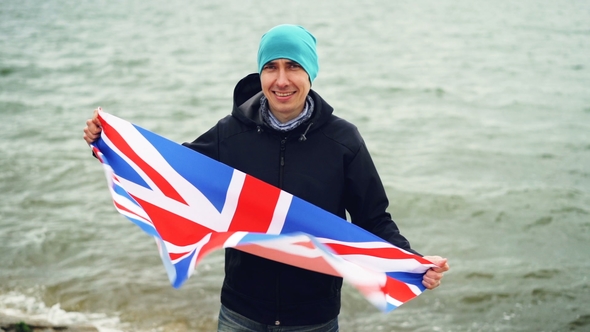 Portrait of Patriotic Englishman Holding Flag of Great Britain Standing ...