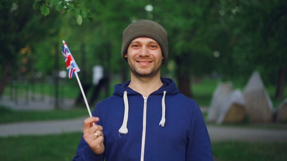 Portrait of Englishman in Sports Clothes Holding Official British Flag ...