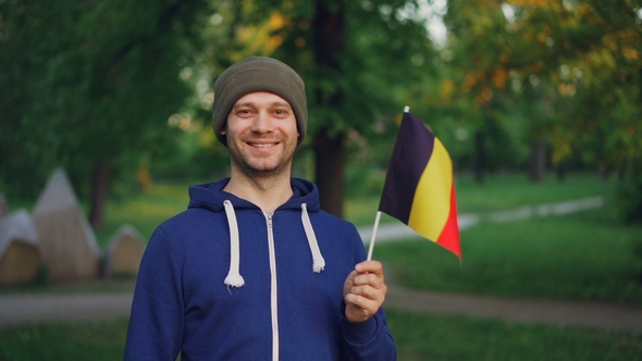 Portrait of Belgian Man in Sports Jacket and Hat Holding National Flag ...