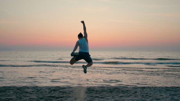 Happy Man Is Running Fast and Jumping High at the Sea Coast on Beach at ...