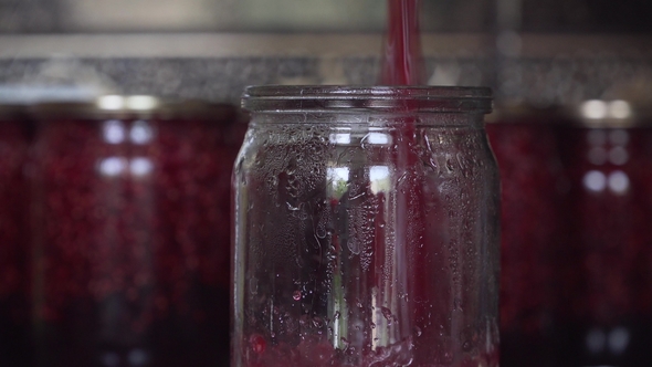 Raspberry Jam Is Poured Into Glass Jar for Preservation and Covered ...