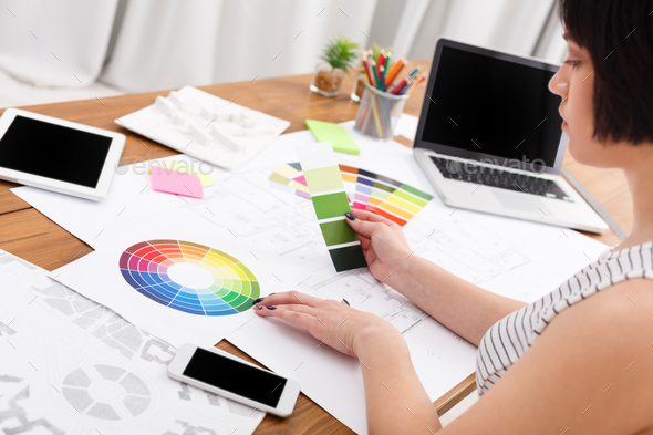 Designer's working table with color palette Stock Photo by Prostock-studio