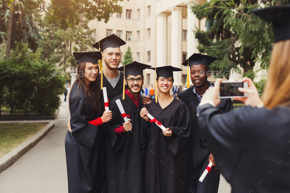 Group of students taking photo on graduation day Stock Photo by ...