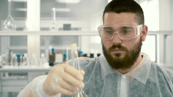 Laboratory Assistant Mixing Red Liquid in a Flask, Stock Footage ...