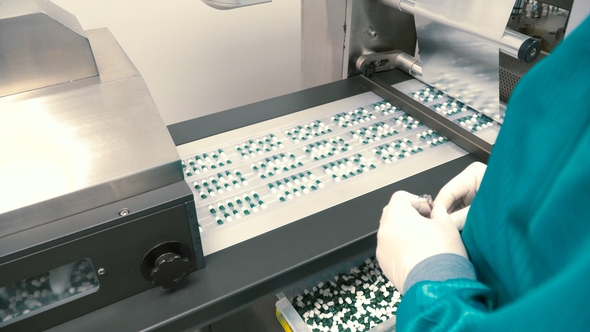 Worker Control the Process of Sorting Capsules Into Packages, Stock Footage