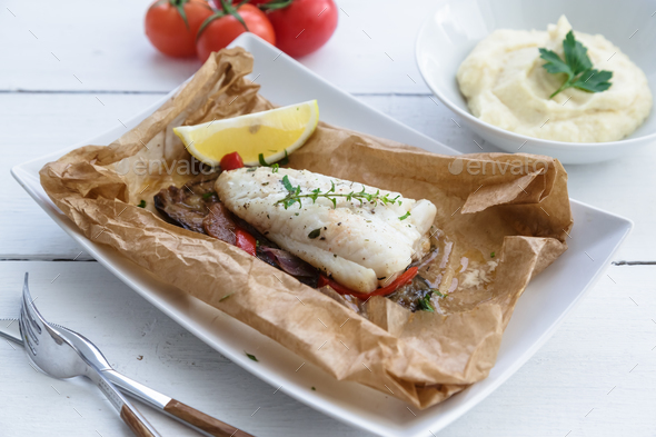 Cod fillets baked in parchment paper with vegetables Stock Photo by ...