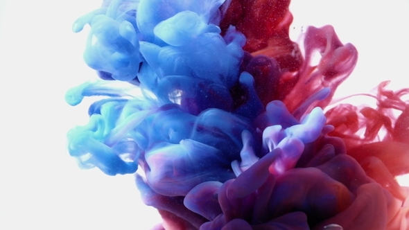 Blue and Red Ink Mixing Together Over a Pure White Background ...