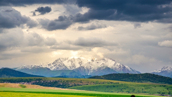 Snow-capped Mountain Top Against a Backdrop of Thunderclouds and Wheat ...
