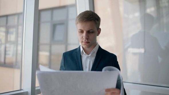 Young Handsome Businessman Looking at Startup Project, Standing in ...