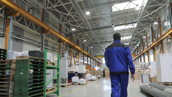 Factory Worker Walking Through Industrial Facilities, Stock Footage