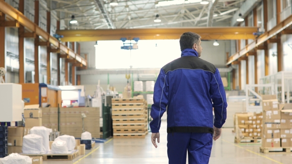 Follow Footage of Factory Worker That Is Walking Through Industrial ...