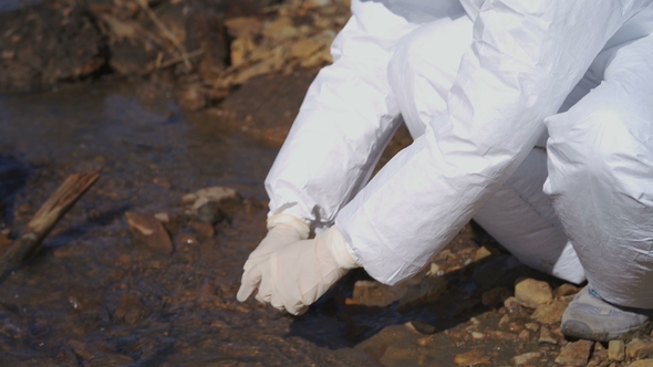 Female Researcher in Protective Clothing Making Experiment in Arid ...