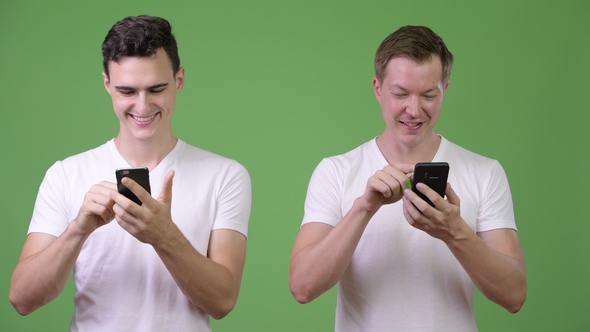 Two Happy Young Handsome Men Using Phones Together, Stock Footage ...
