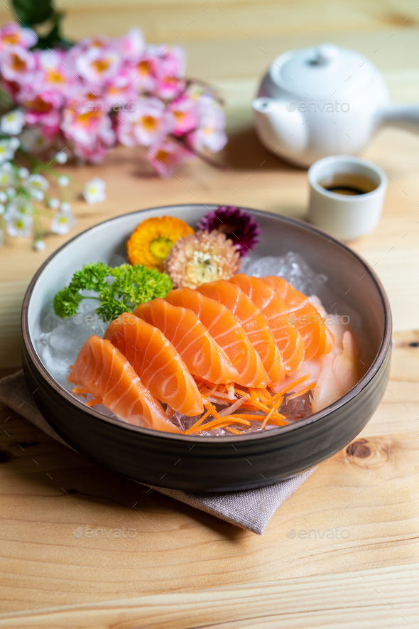 Salmon sashimi slice fresh serve on ice with tea, Japanese style Stock ...