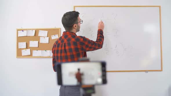 Young Male Math Teacher Explaining Hard Math Equation in Online Class ...