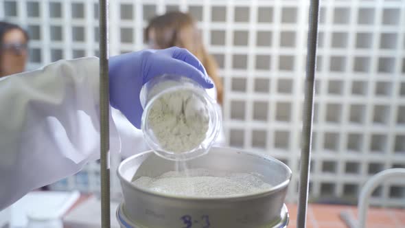 Students working in laboratory and chemical material pouring process ...