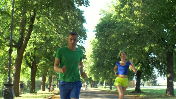 Cheerful Female Runner Overtake Man on Park Trail, Stock Footage ...