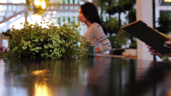 A Girl with a Menu Goes To the Bar Counter, Stock Footage | VideoHive
