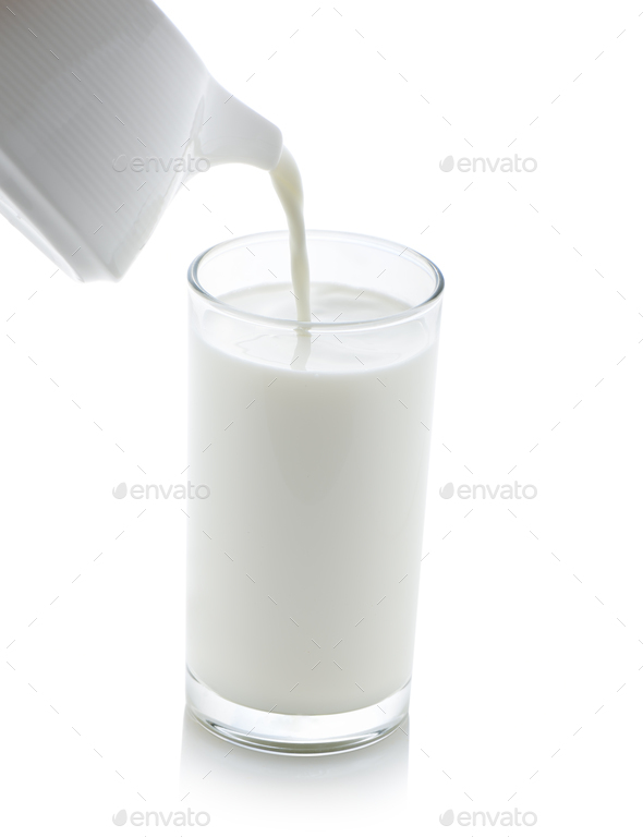 Milk pouring from a jug into a glass on white background Stock Photo by ...