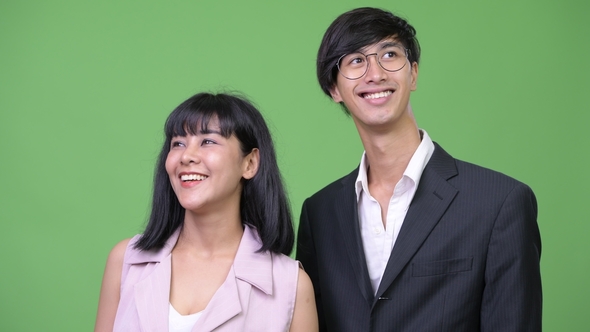Young Happy Asian Business Couple Thinking Together, Stock Footage