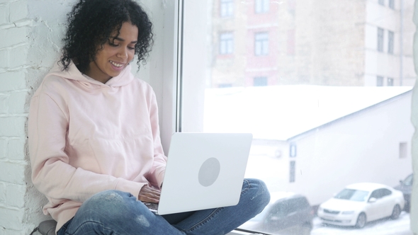 Online Video Chat By African Woman, Sitting at Window, Stock Footage