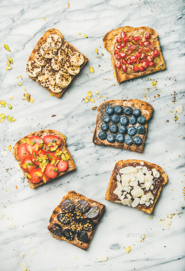Vegan whole grain toasts with fruit, seeds, nuts, top view Stock Photo ...