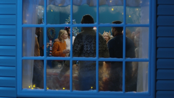 Excited Friends Looking Out in Window During Christmas, Stock Footage