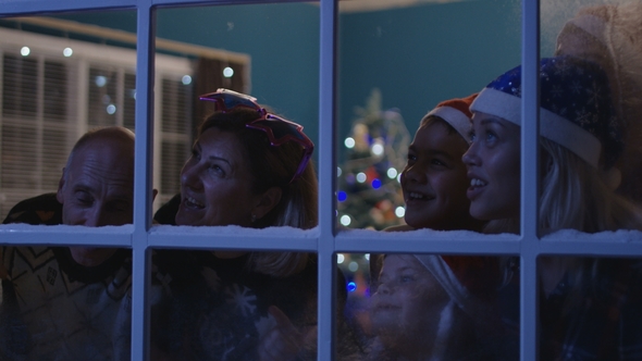 Happy Family Watching Fireworks Through Window, Stock Footage | VideoHive