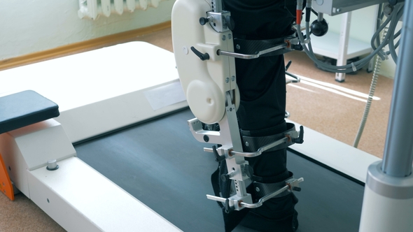 of Legs of a Male Patient Getting Trained By a Track Machine, Stock Footage