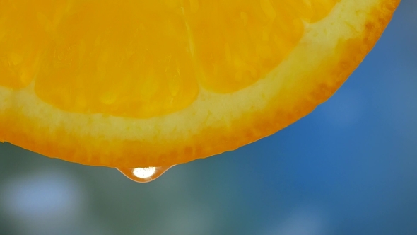 A Drop of Pure Water or Juice Dripping From a Slice of Orange, Stock ...