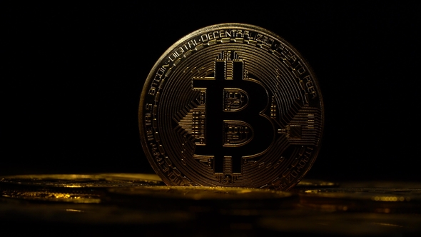 Bitcoins Are Spinning in a Circle in the Dark on a Black Background ...