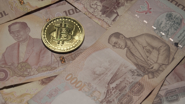 Bitcoin on Thai Baht Banknotes Rotating on Turntable, Stock Footage