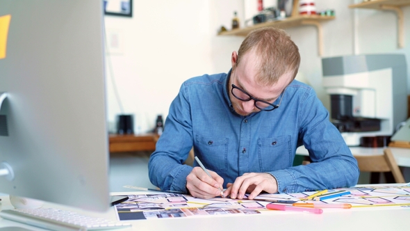 Hipster Engineer Works with Blueprint. Shoot From Above. Young ...