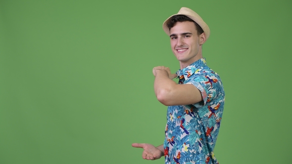 Young Handsome Tourist Man Showing Something, Stock Footage | VideoHive