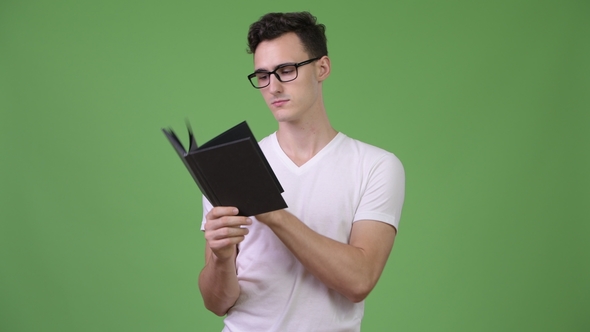 Young Handsome Nerd Man Reading Book, Stock Footage | VideoHive
