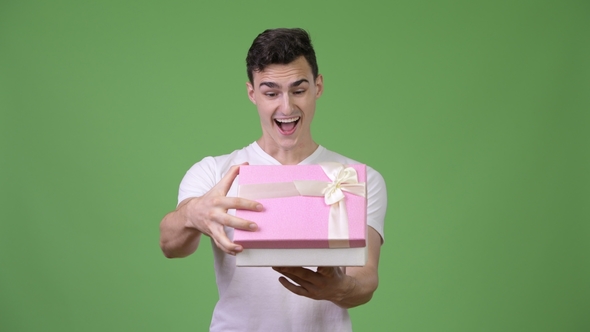 Young Surprised Man Opening Gift Box, Stock Footage | VideoHive
