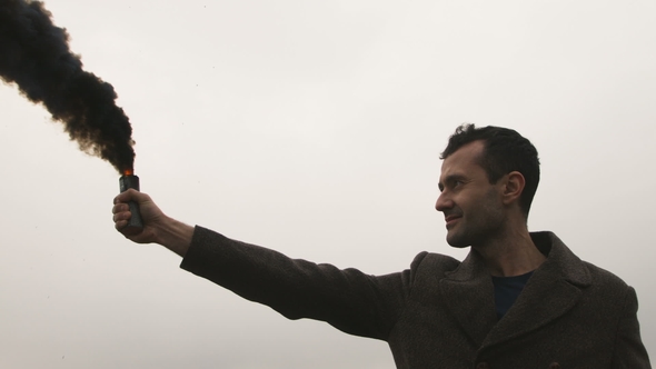 Serious Man Holding Smoke Bomb with Black Fume, Stock Footage | VideoHive