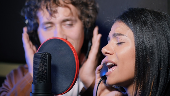 Two Young Singers Performing Their Song in Record Studio. Professional ...