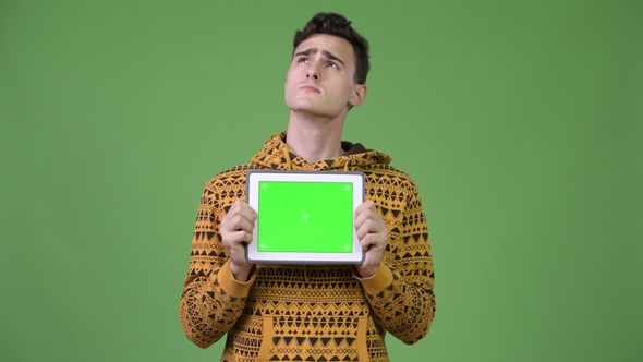 Young Handsome Man Thinking While Showing Digital Tablet, Stock Footage