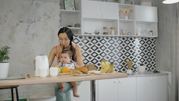 Young Asian Mother Holding Little Baby on the Knees, Sitting in the ...