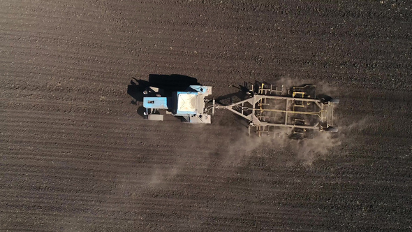 Aerial View of Agricultural Tractor Cultivating Field. Tractor At Work ...