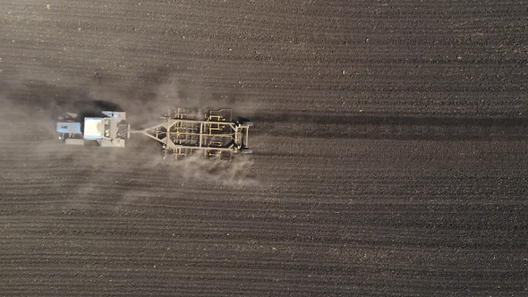 Aerial View of Agricultural Tractor Cultivating Field. Tractor At Work ...