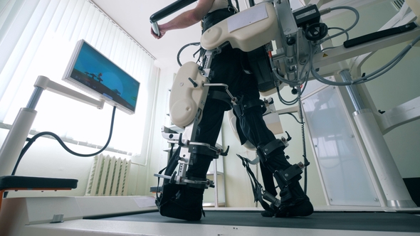 Medical Room with a Male Patient Undergoing a Walking Track Training ...