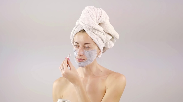 Girl Smears Face with a Mask of Cream. Medical Mask To Smear the Face ...