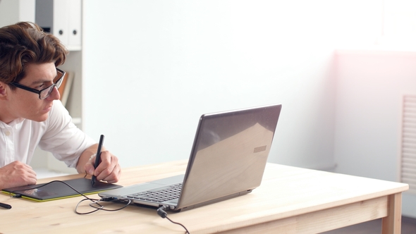 Office Work Concept. Graphic Designer Sitting at Desk with Laptop and ...