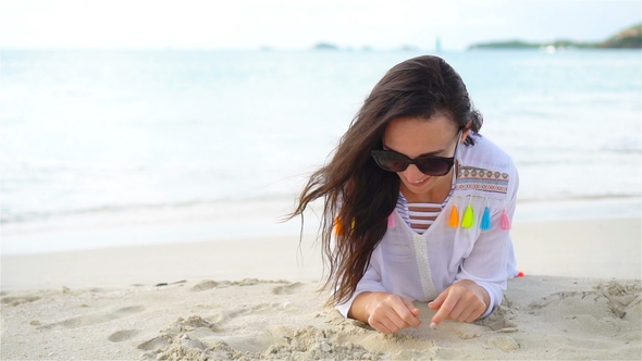 Young Beautiful Girl Lying on the Beach at Shallow Tropical Water ...