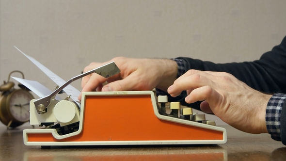 Male Hands Typing on the Old Red Typewriter at the Desk with Books ...