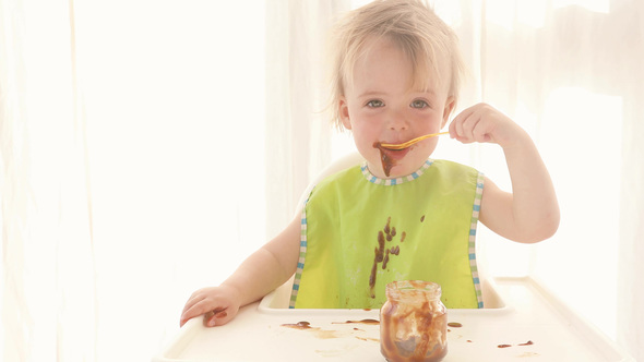 Baby Getting Messy Eating Chocolate Pudding, Stock Footage | VideoHive