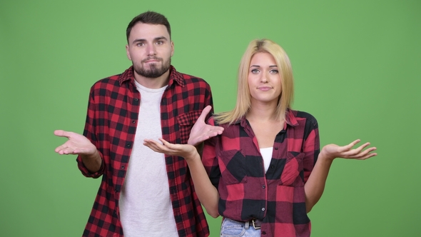 Young Couple Shrugging Shoulders Together, Stock Footage | VideoHive