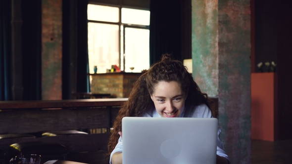 Young Woman Is Looking at Laptop Screen and Laughing, Her Colleagues ...